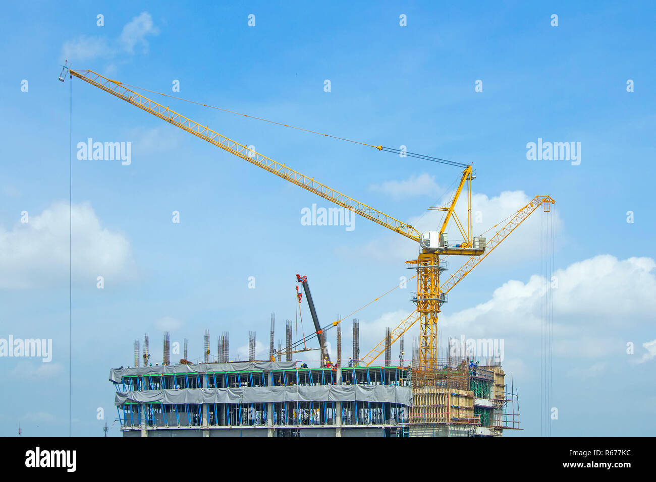 Crane lifts building with construction workers Stock Photo - Alamy