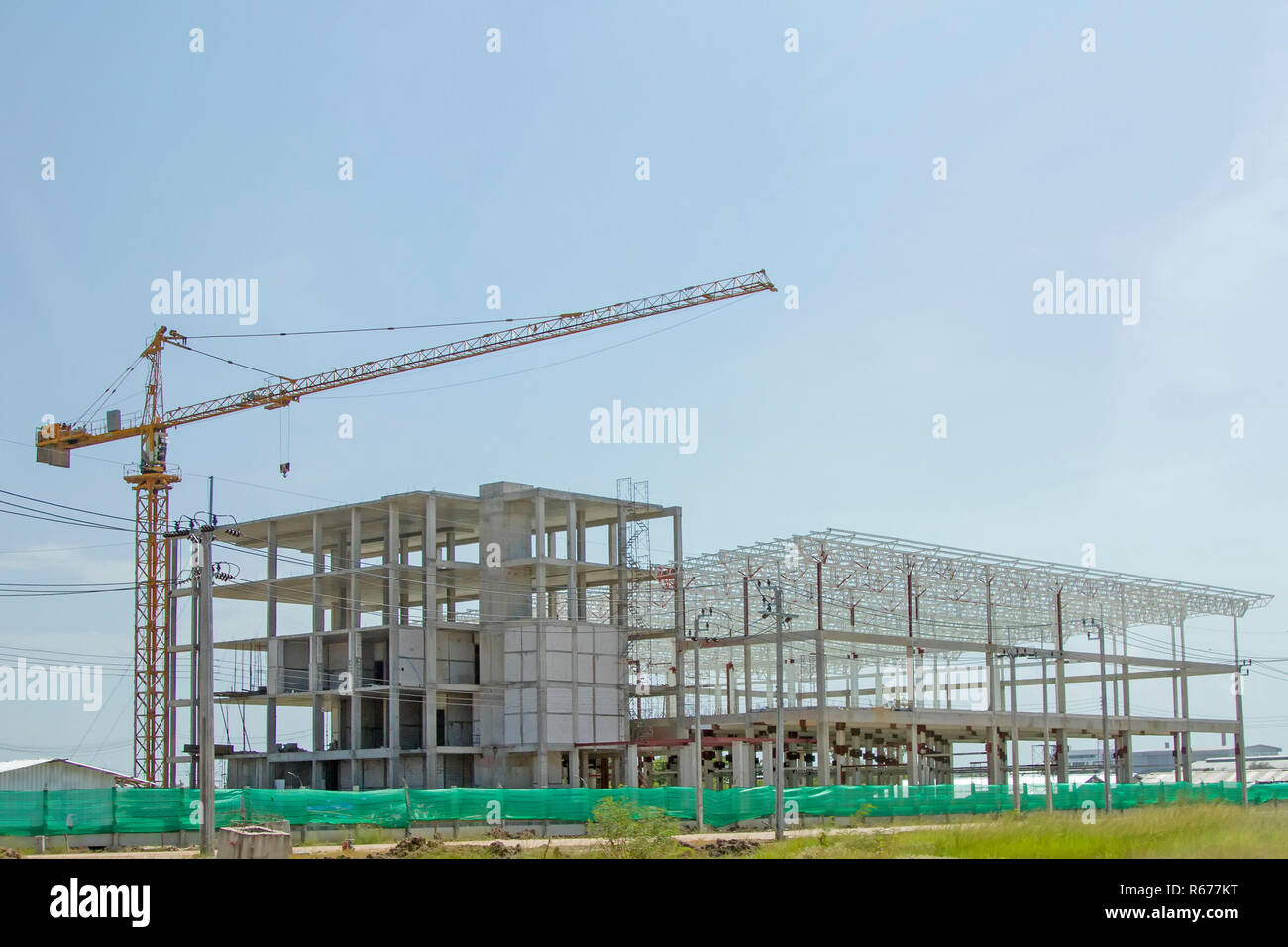 Crane lift with factory under construction Stock Photo - Alamy