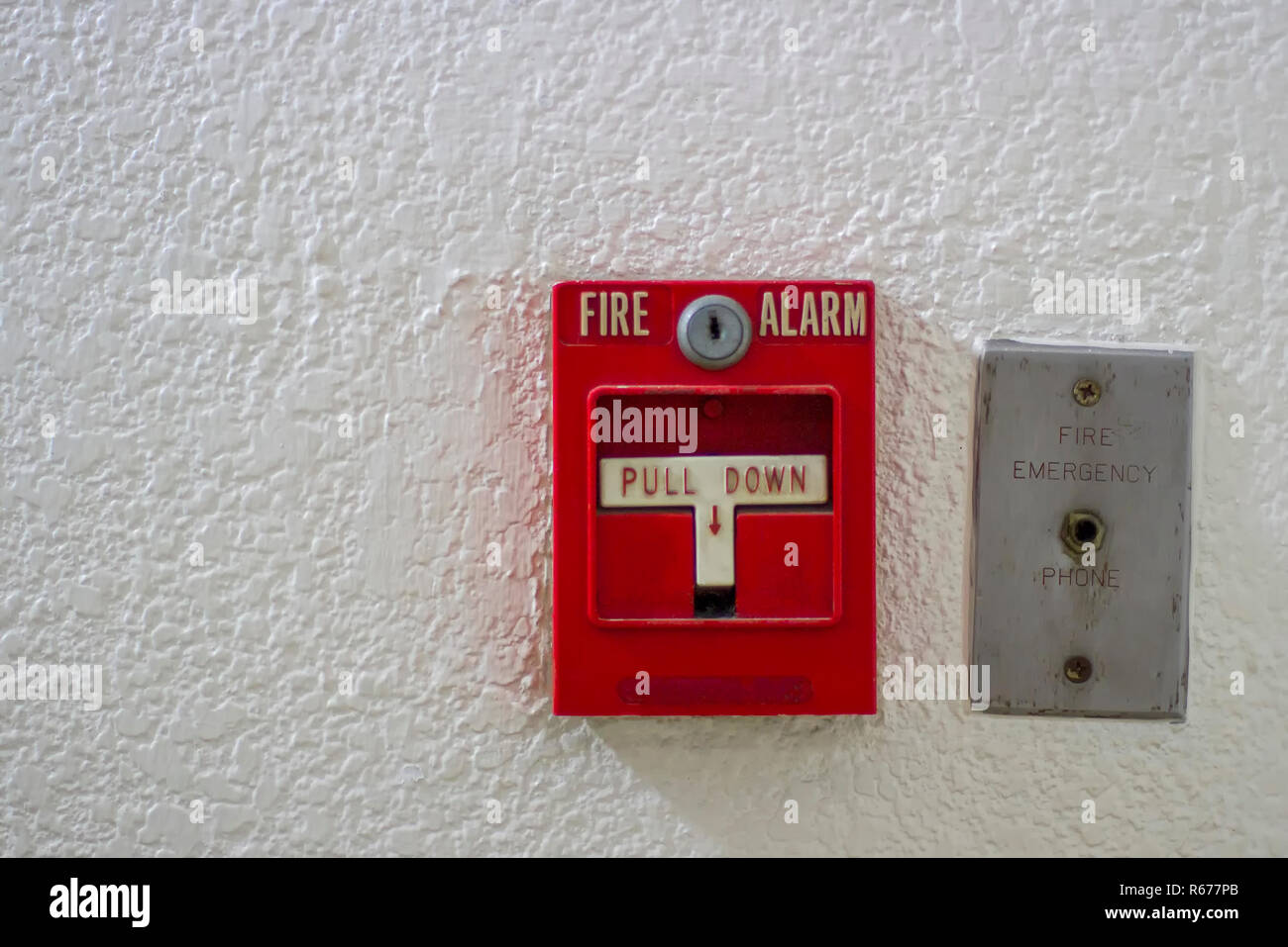 Red antique fire alarm button with white wall Stock Photo - Alamy