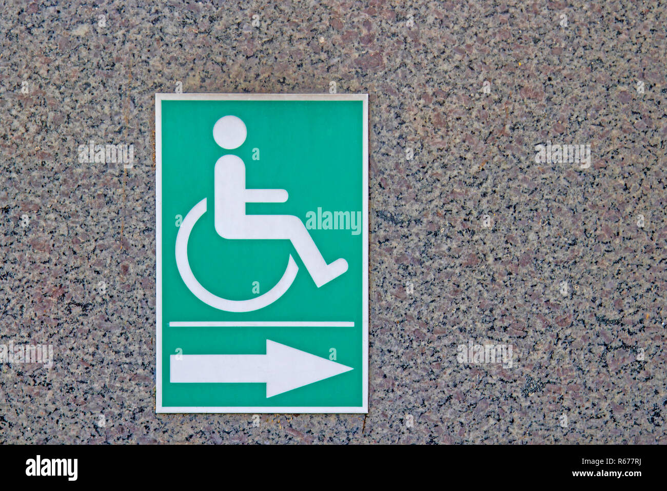 Disabled symbol On the green Stick to the marble walls Stock Photo - Alamy