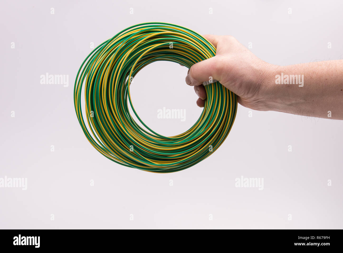 roll of electric cable in hand Stock Photo - Alamy