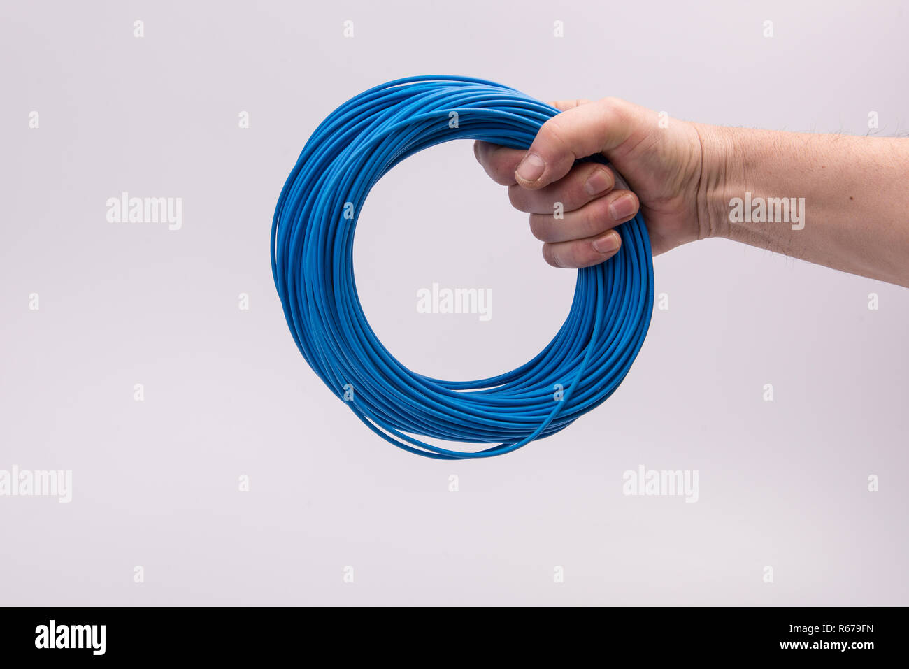 roll of electric cable in hand Stock Photo - Alamy