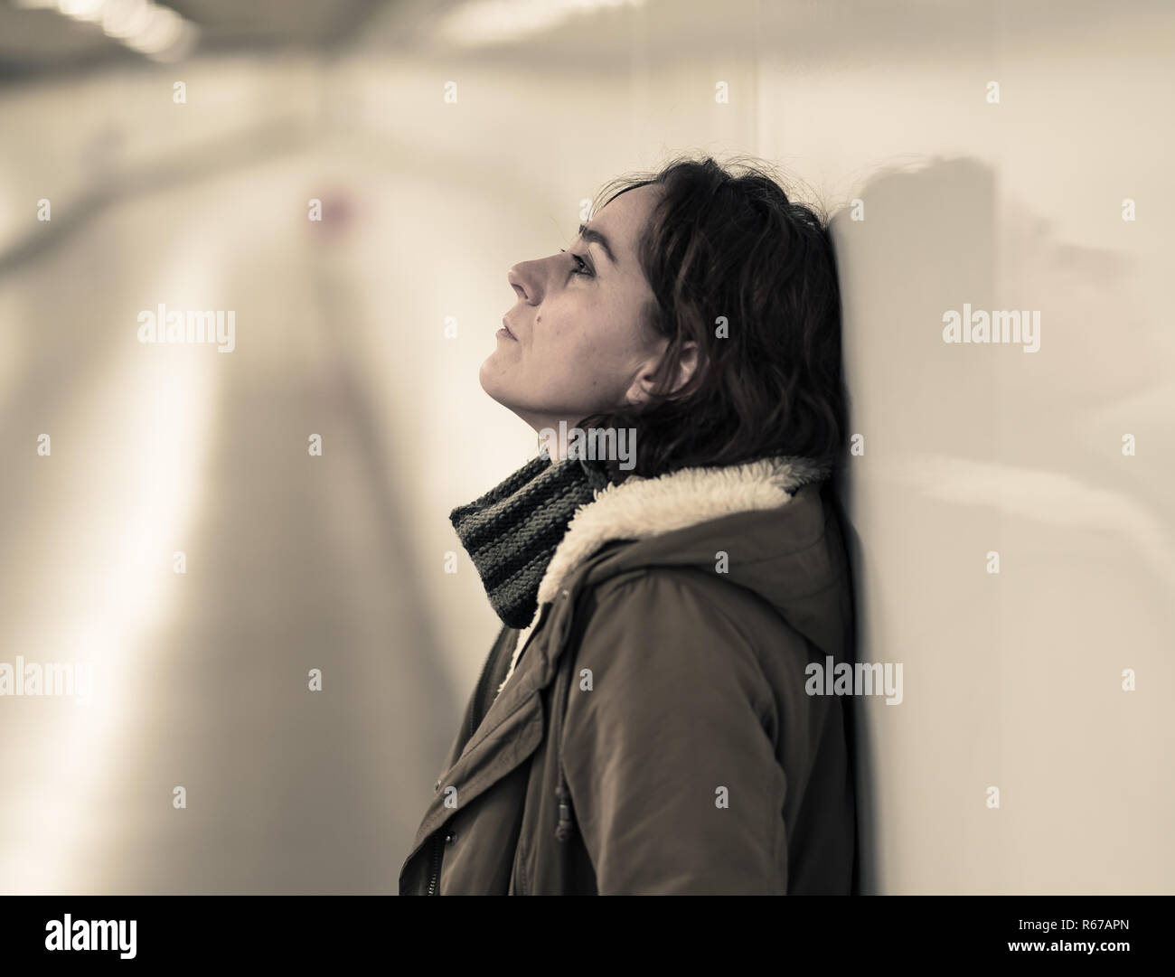 Hopeless and exhausted woman suffering depression and anxiety in subway ...