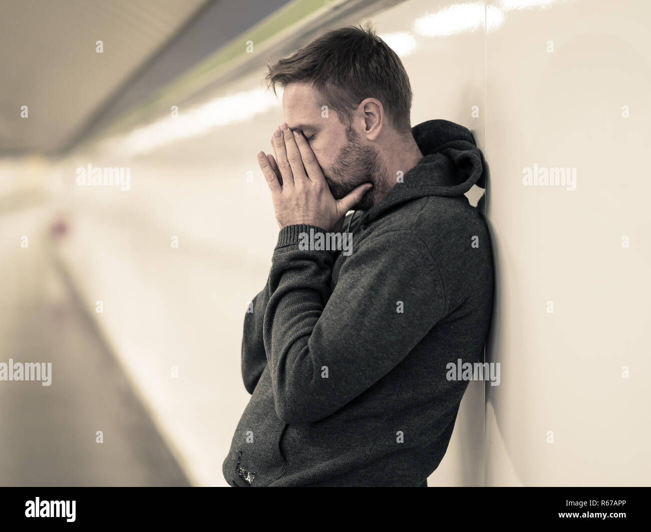 Sad jobless young man crying suffering depression stress sitting on ...