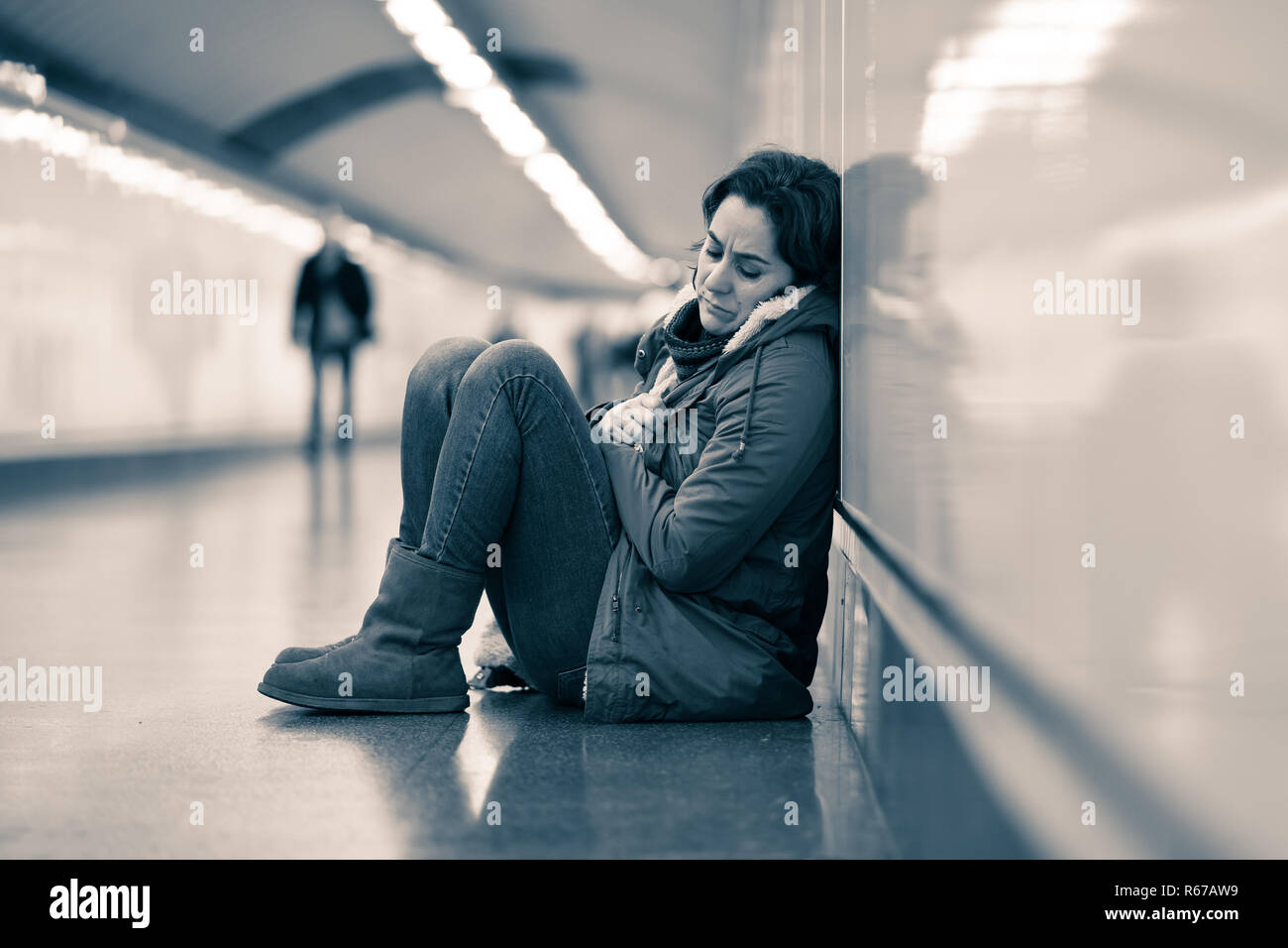 Young adult felling shame depressed and hopeless sitting alone on ...