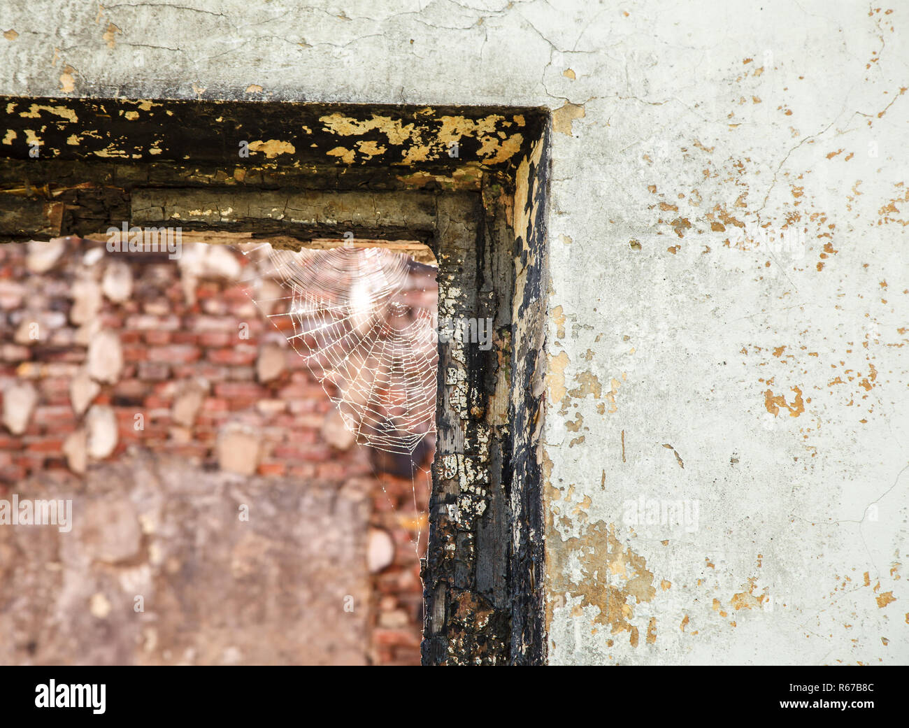 broken window with spiderweb in an abandoned house outdoor closeup ...