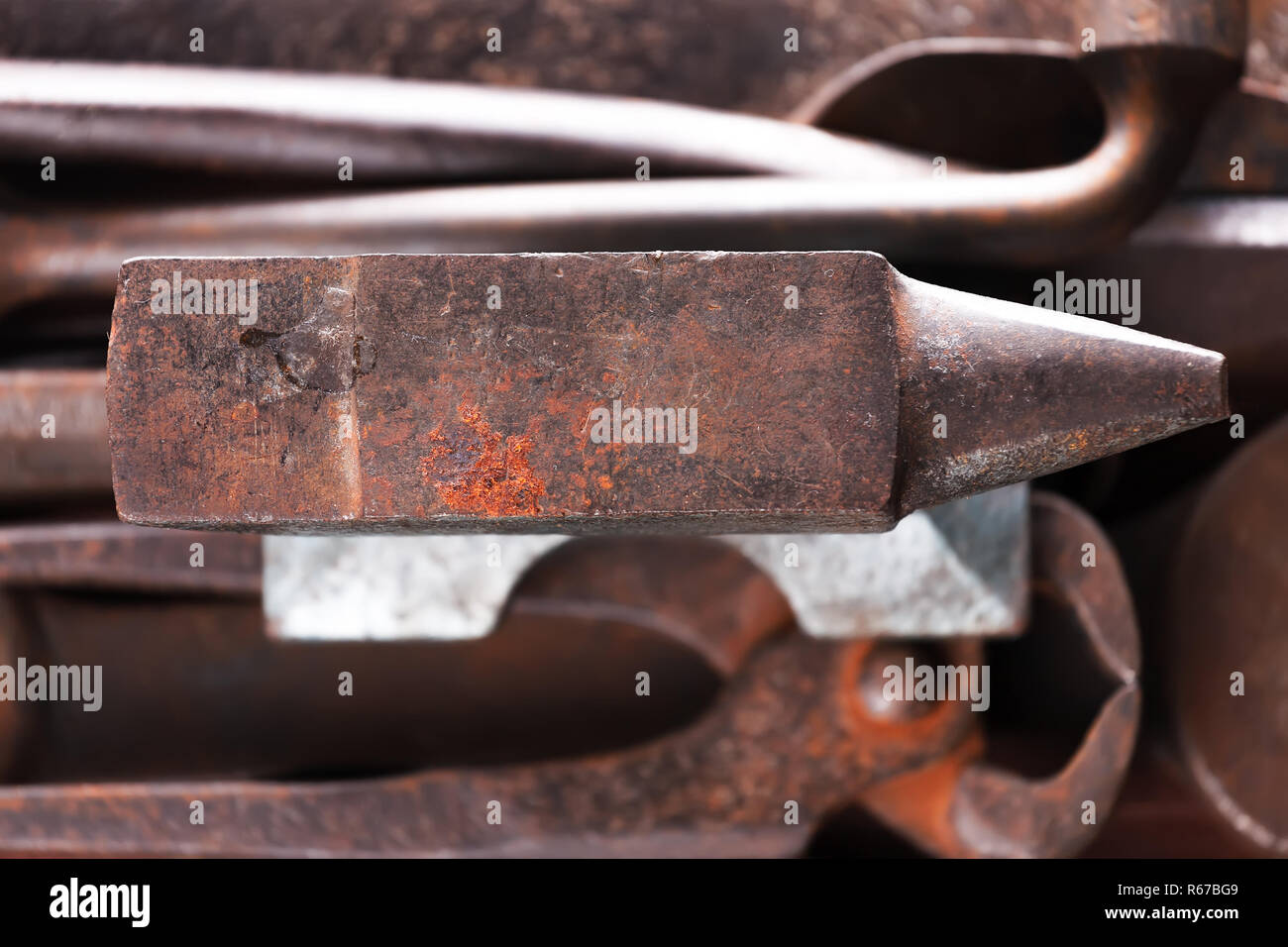 Old rusty rugged anvil on other blacksmith tools. Top view Stock Photo ...