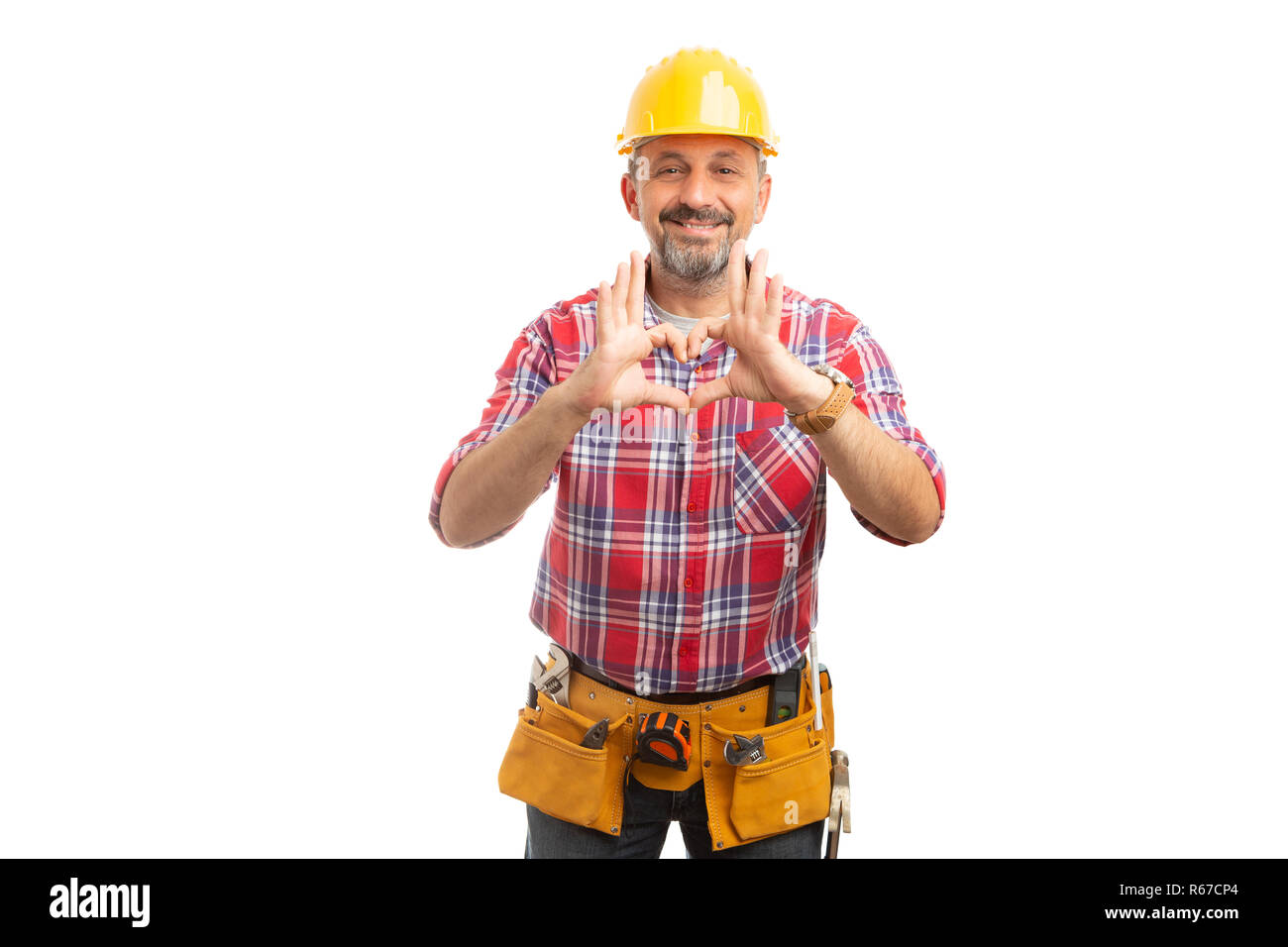Cheerful builder holding heart symbol with fingers as love the job ...