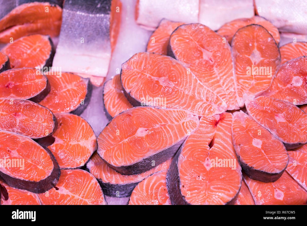 Sliced raw, not cooked salmon, red fish, lying in the ice on the ...