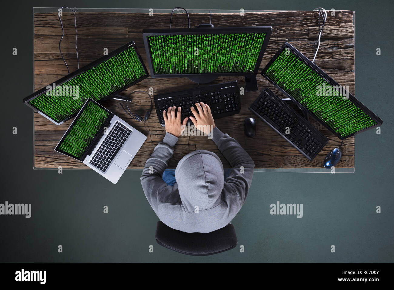 Hacker Hacking Multiple Computers On Desk Stock Photo - Alamy