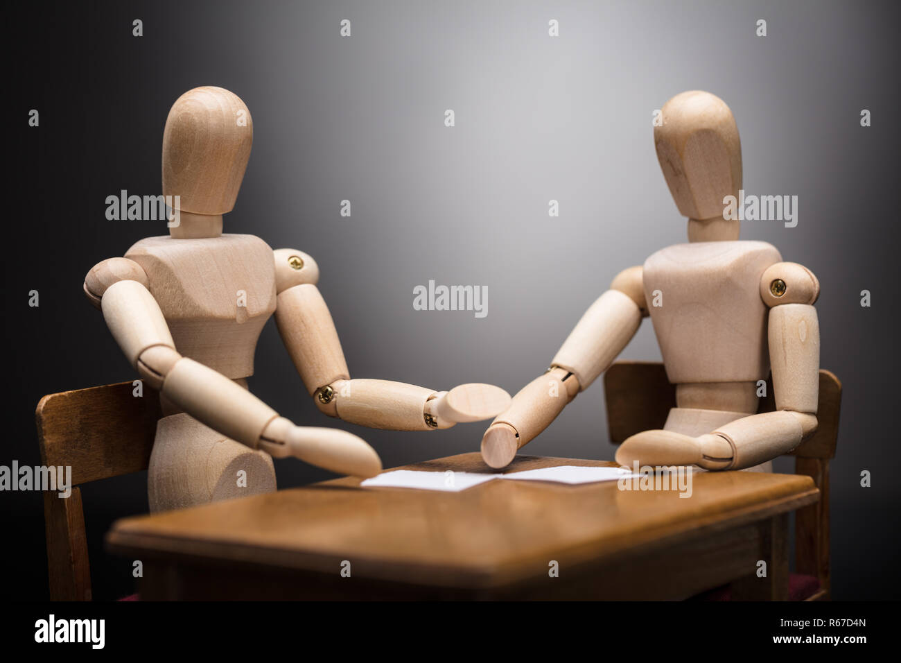 Two Wooden Dummy Figures Making Business Plan Stock Photo - Alamy