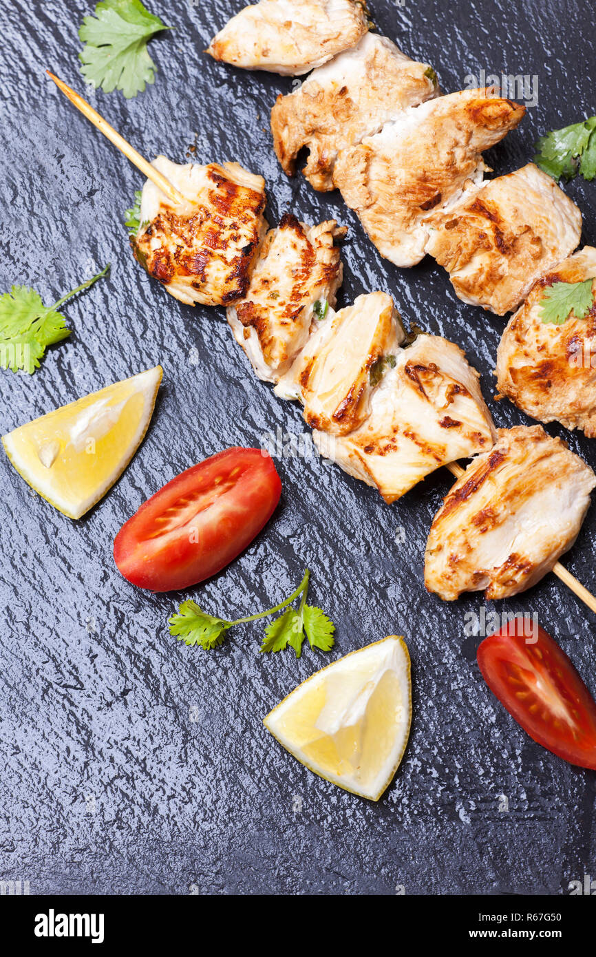 grilled chicken spit with cilantro Stock Photo - Alamy