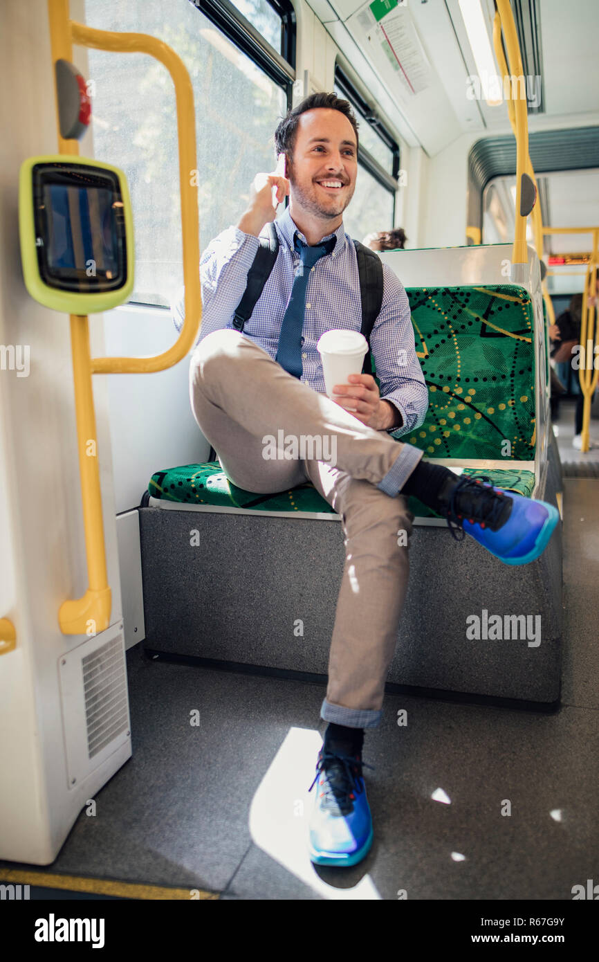 Talking On Phone While Commuting By Tram Stock Photo - Alamy