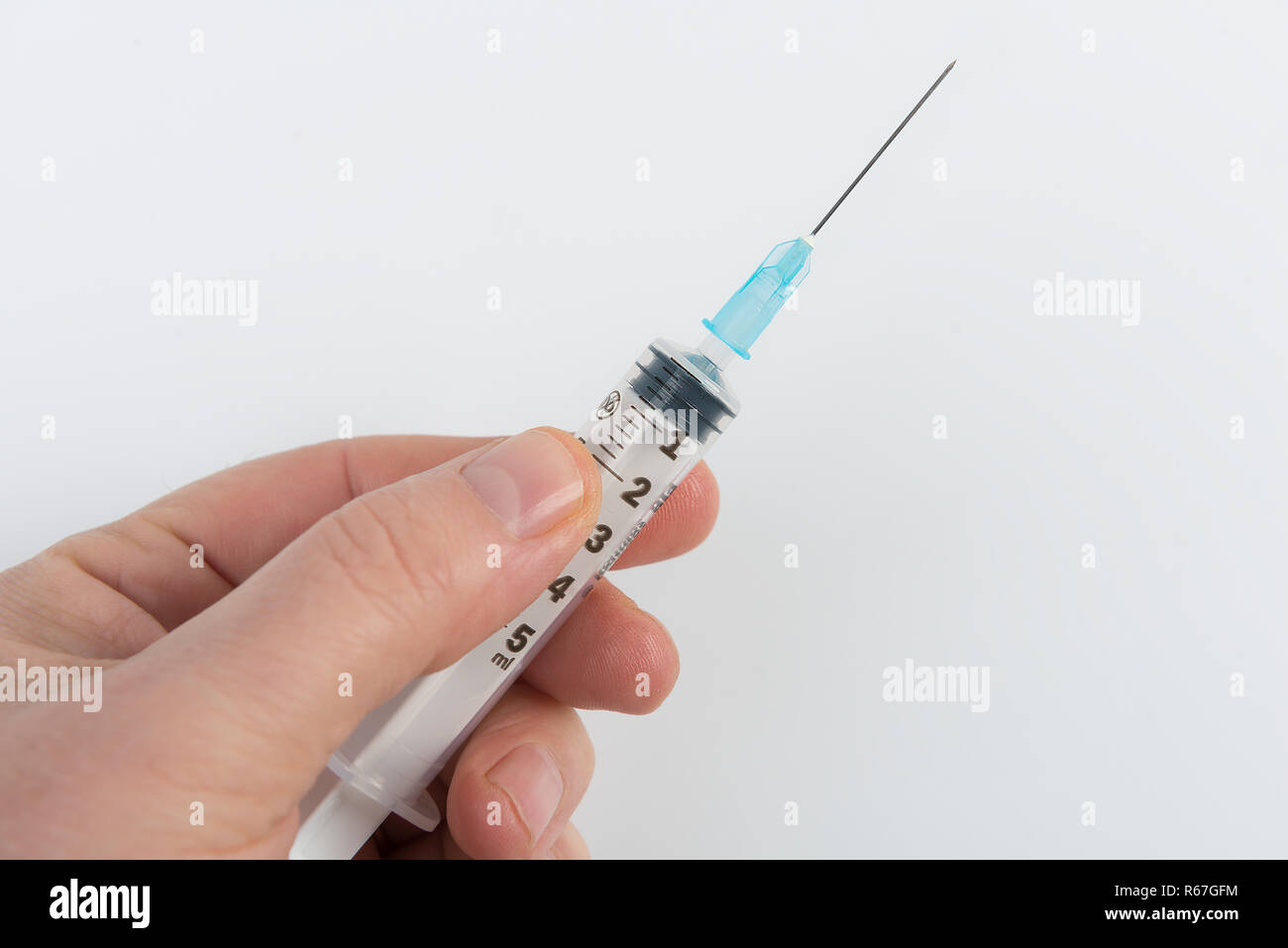 a syringe in his hand Stock Photo - Alamy