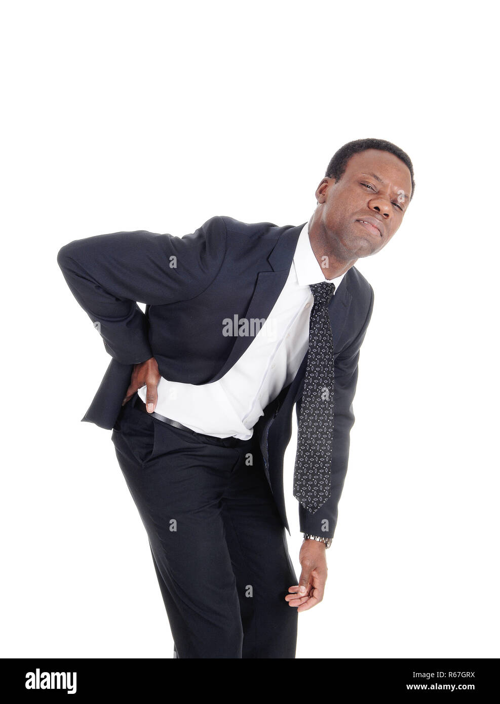 Man with back pain bending forward Stock Photo - Alamy
