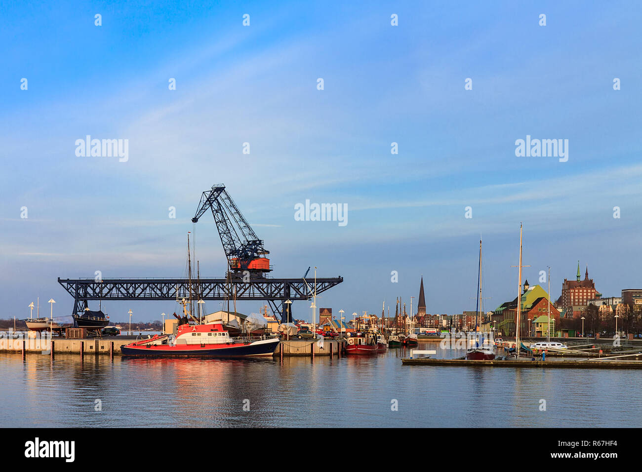 view of the city harbor of rostock in the evening Stock Photo - Alamy