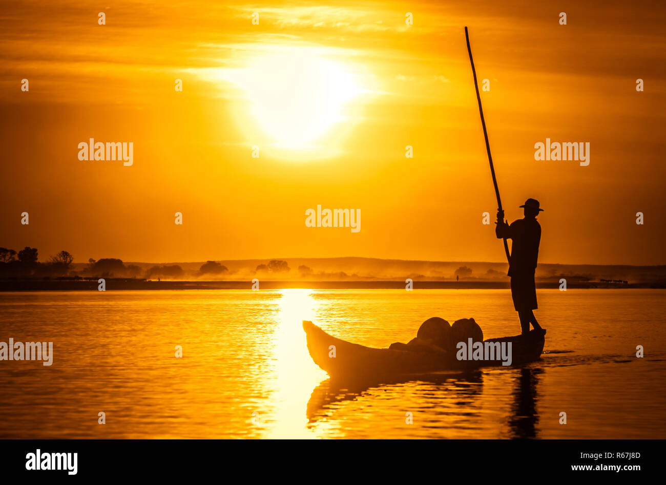 Pirogue at sunset Stock Photo - Alamy