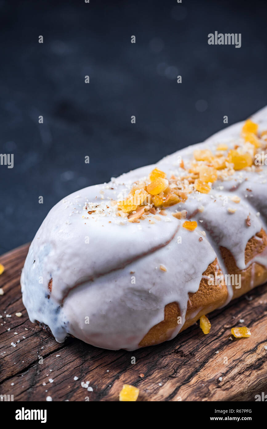 Poppy seed Christmas cake with icing and candied orange Stock Photo - Alamy