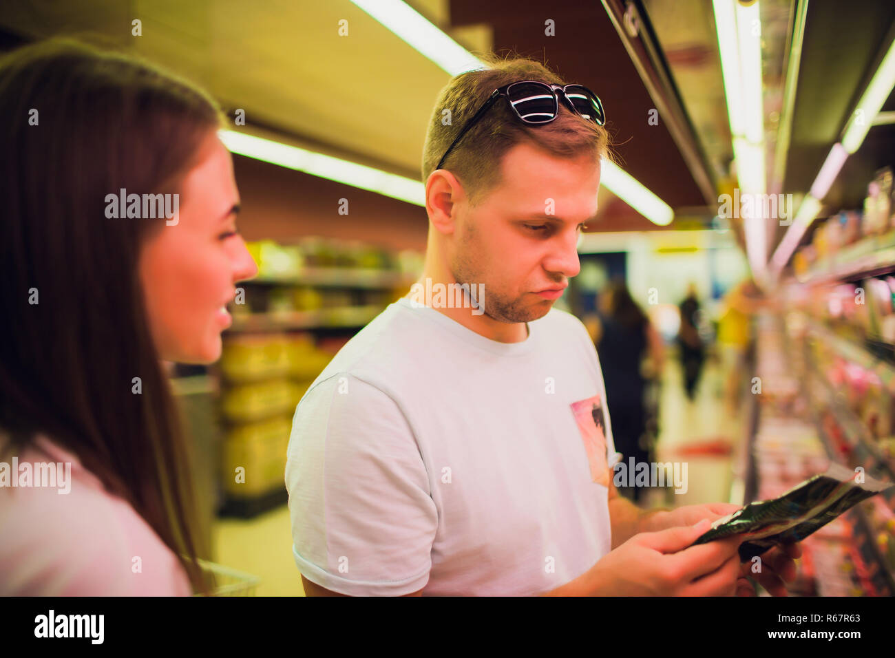 Portrait man customer who is standing with purchases in supermarket ...