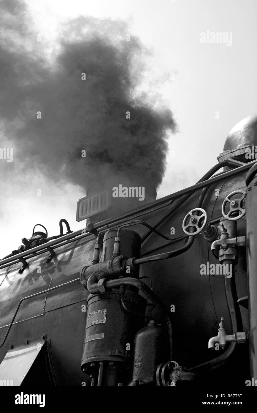 Detail of Vintage steam engine, working, with smoke - converted to ...