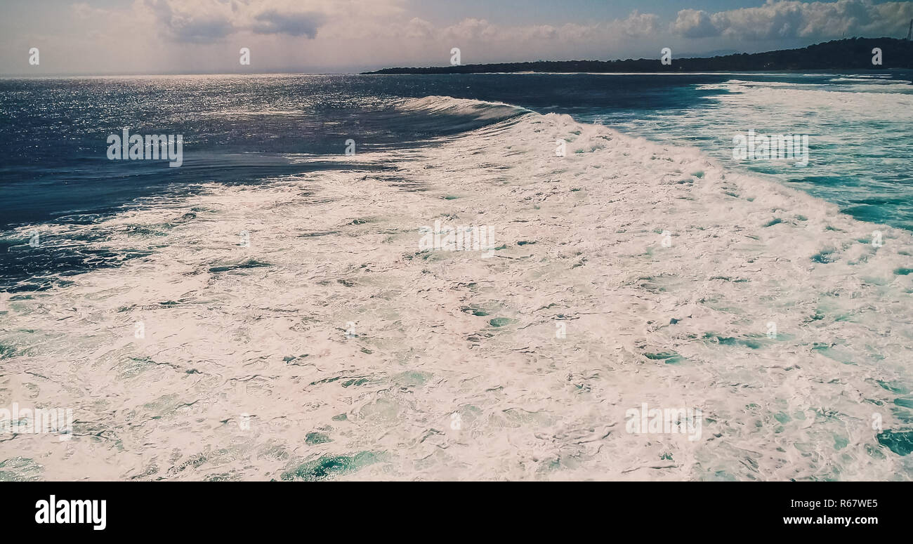 Dawn above sea. Beach, waves, sea, pier on background of rising sun ...