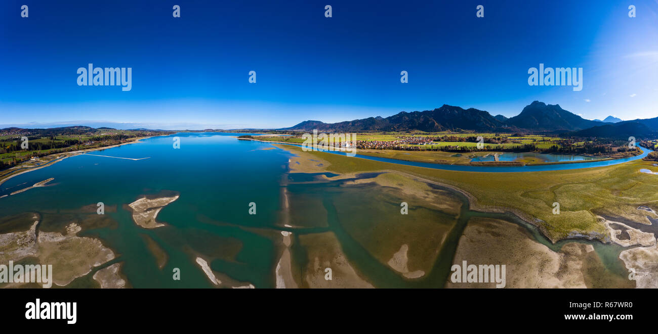 Reservoir Forggensee with sandbanks at low tide due to drought, drone ...
