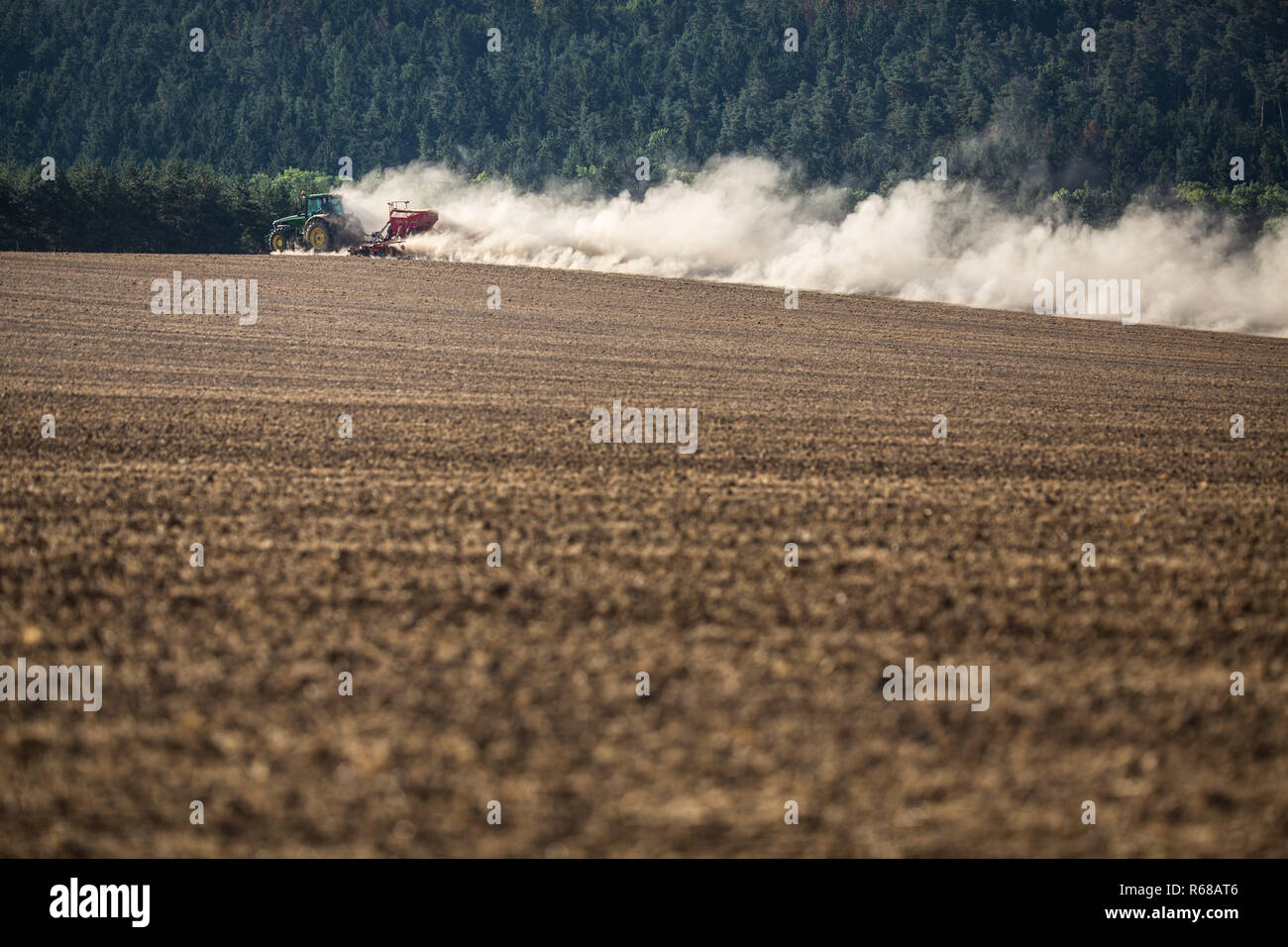 Tractor plowing a dry farm field Stock Photo - Alamy