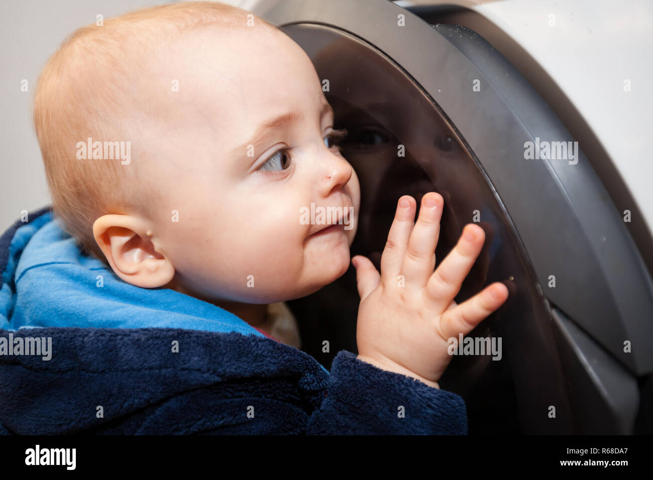 Listening to the washing machine Stock Photo - Alamy
