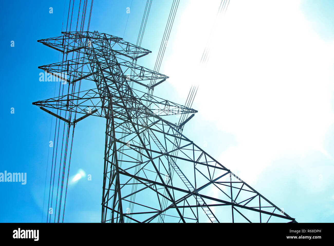 High voltage electric pole with blue sky and engineering background ...