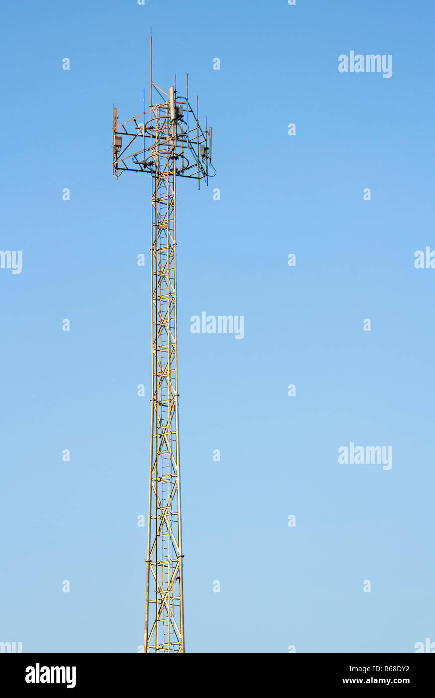 Mobile phone communication tower transmission signal with blue sky ...