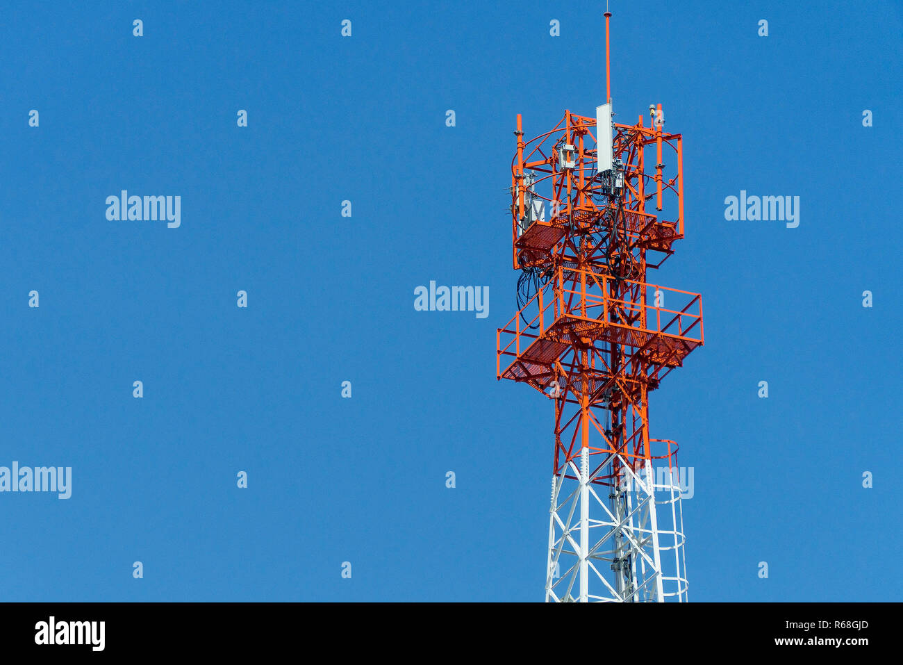Mobile phone communication tower transmission signal with blue sky ...