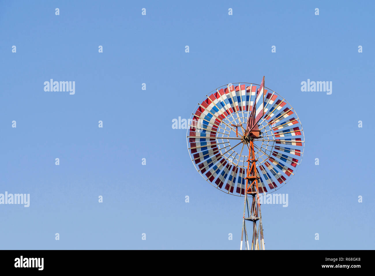 Wind turbine of red, white, blue color and old with blue sky Stock ...
