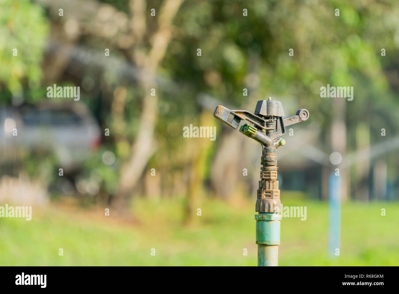 Old water springer against a green background Stock Photo - Alamy