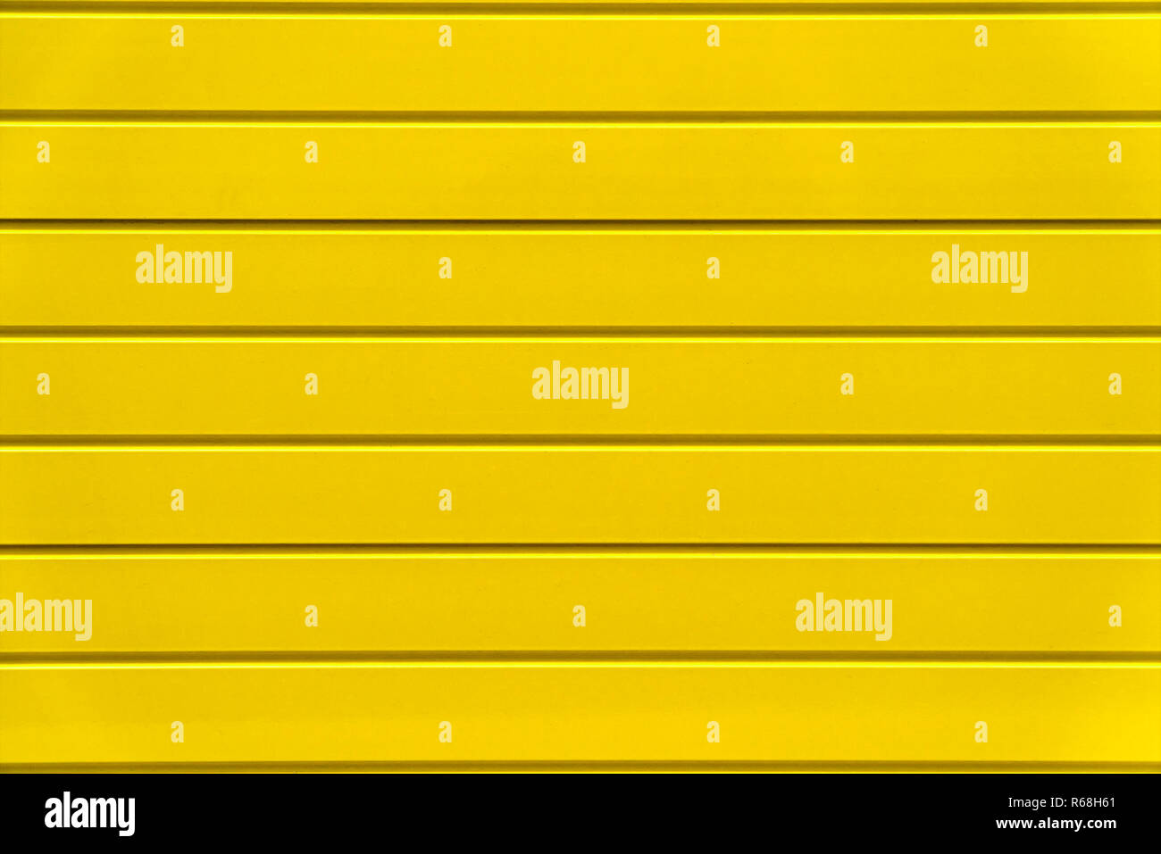 Aluminium dark yellow list with metal sheet fence Stock Photo - Alamy
