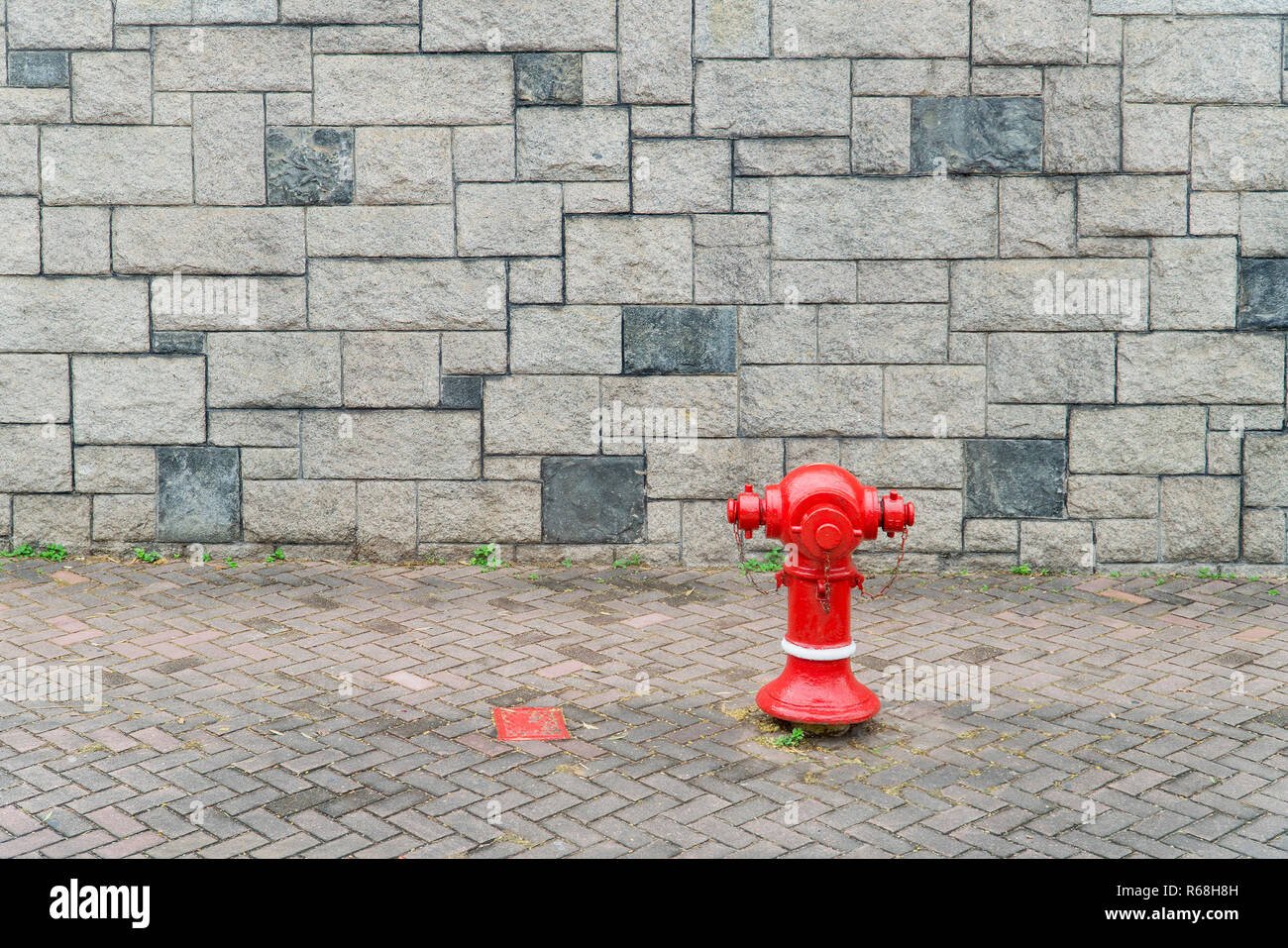 Fire hose water outlet red brick wall gray background Stock Photo - Alamy