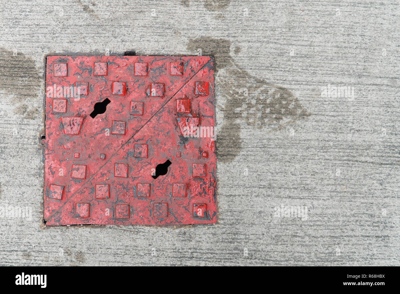 Steel drain hatch classic view of red and square Stock Photo - Alamy