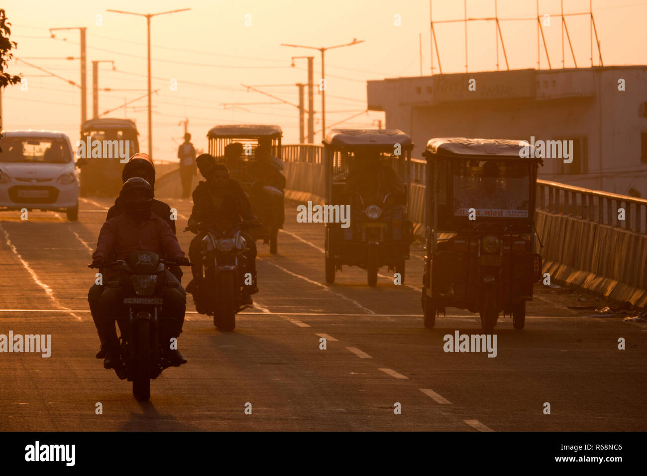 Auto rickshaws and traffic on overpass at sunset in Jaipur, Rajasthan ...