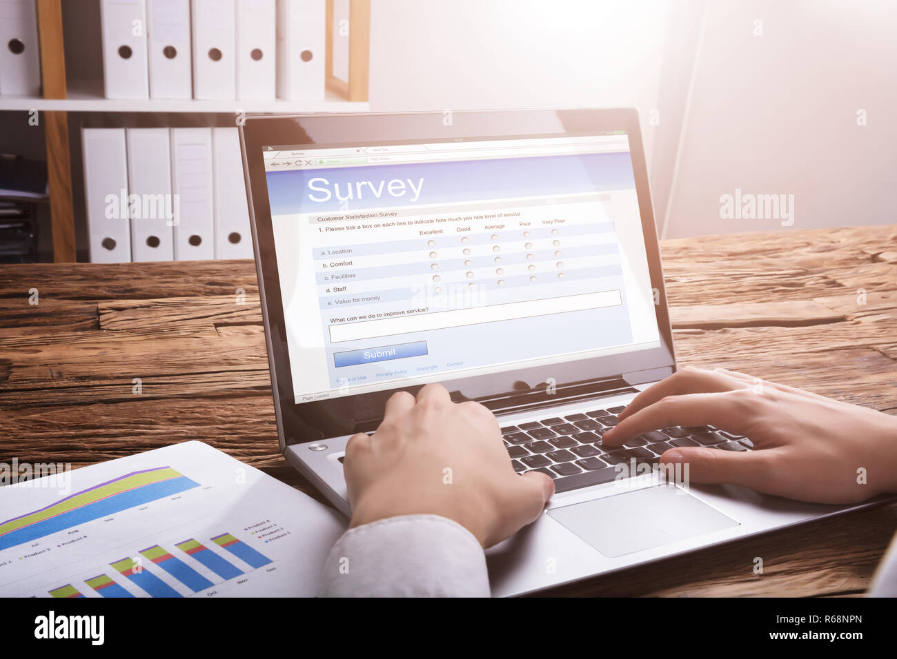 Businessperson Filling Online Survey Form On Laptop Stock Photo - Alamy