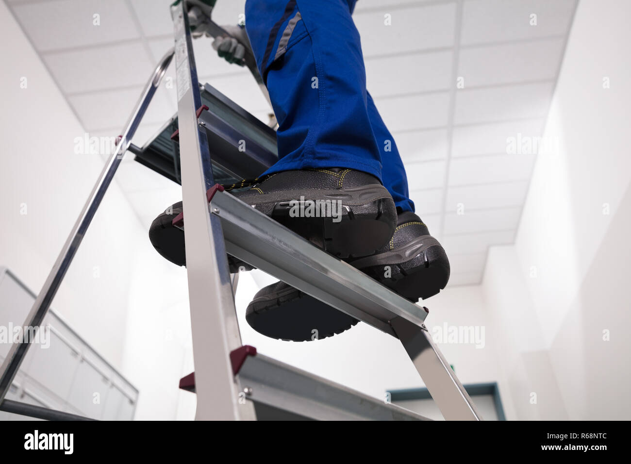 Man Standing On Ladder Stock Photo - Alamy