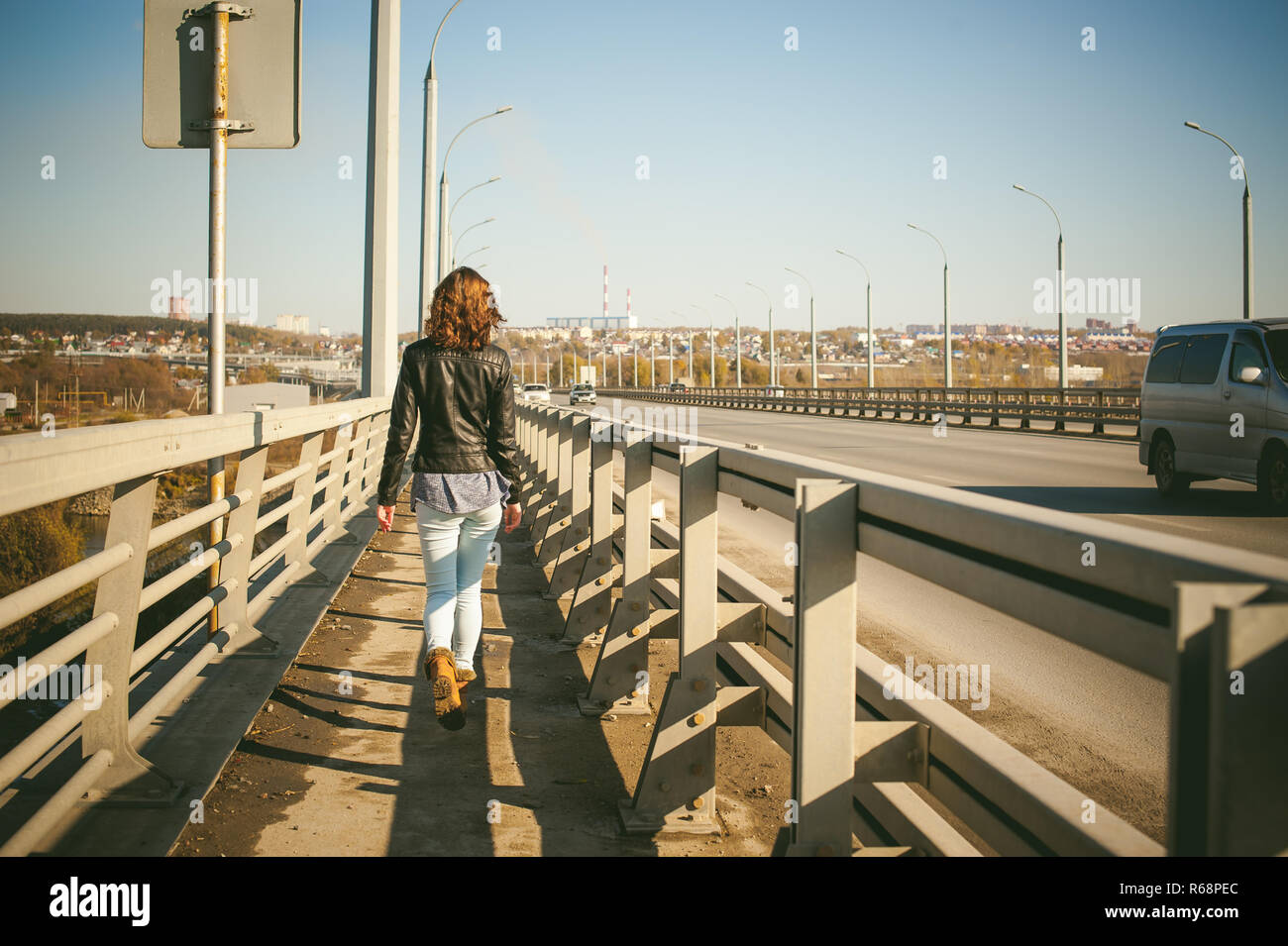 Lonely woman walking over bridge hi-res stock photography and images ...