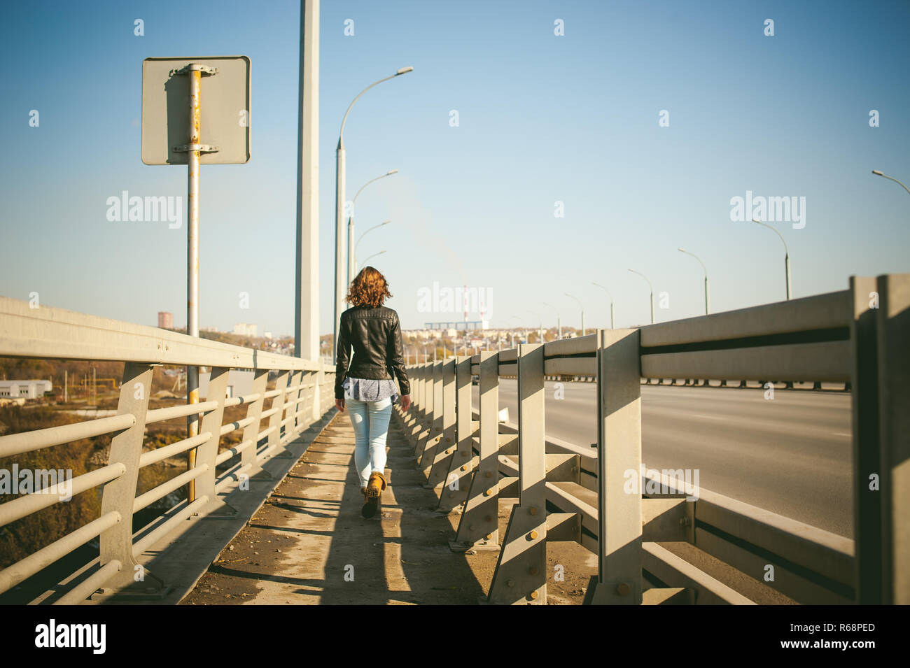 Lonely woman walking over bridge hi-res stock photography and images ...