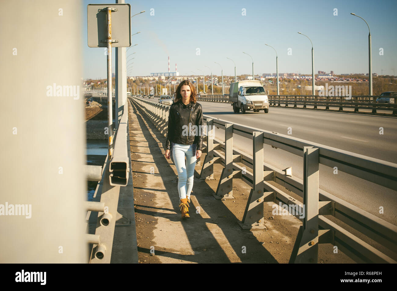 Lonely woman walking over bridge hi-res stock photography and images ...