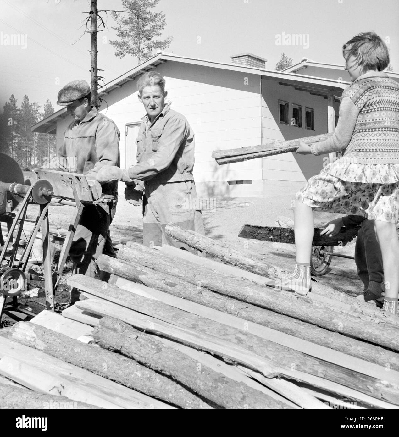 Cutting timber logs to build new wooden homes, Finland 1963 Stock Photo ...