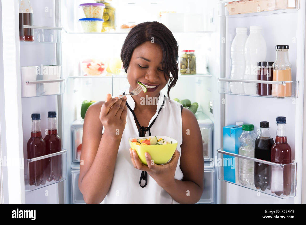 African Woman Eating Fruits In Bowl Stock Photo - Alamy