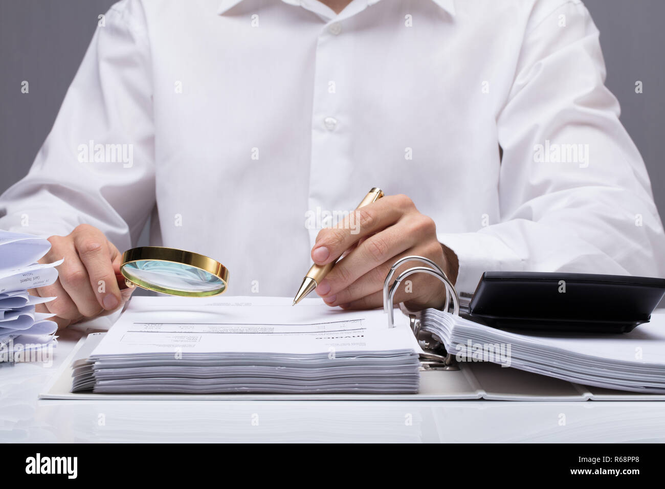 Businessman examining invoice magnifying hi-res stock photography and ...