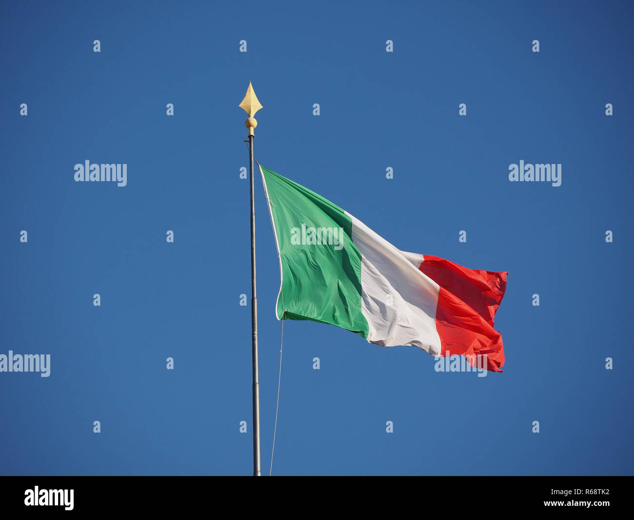 Italian Flag of Italy over blue sky Stock Photo - Alamy