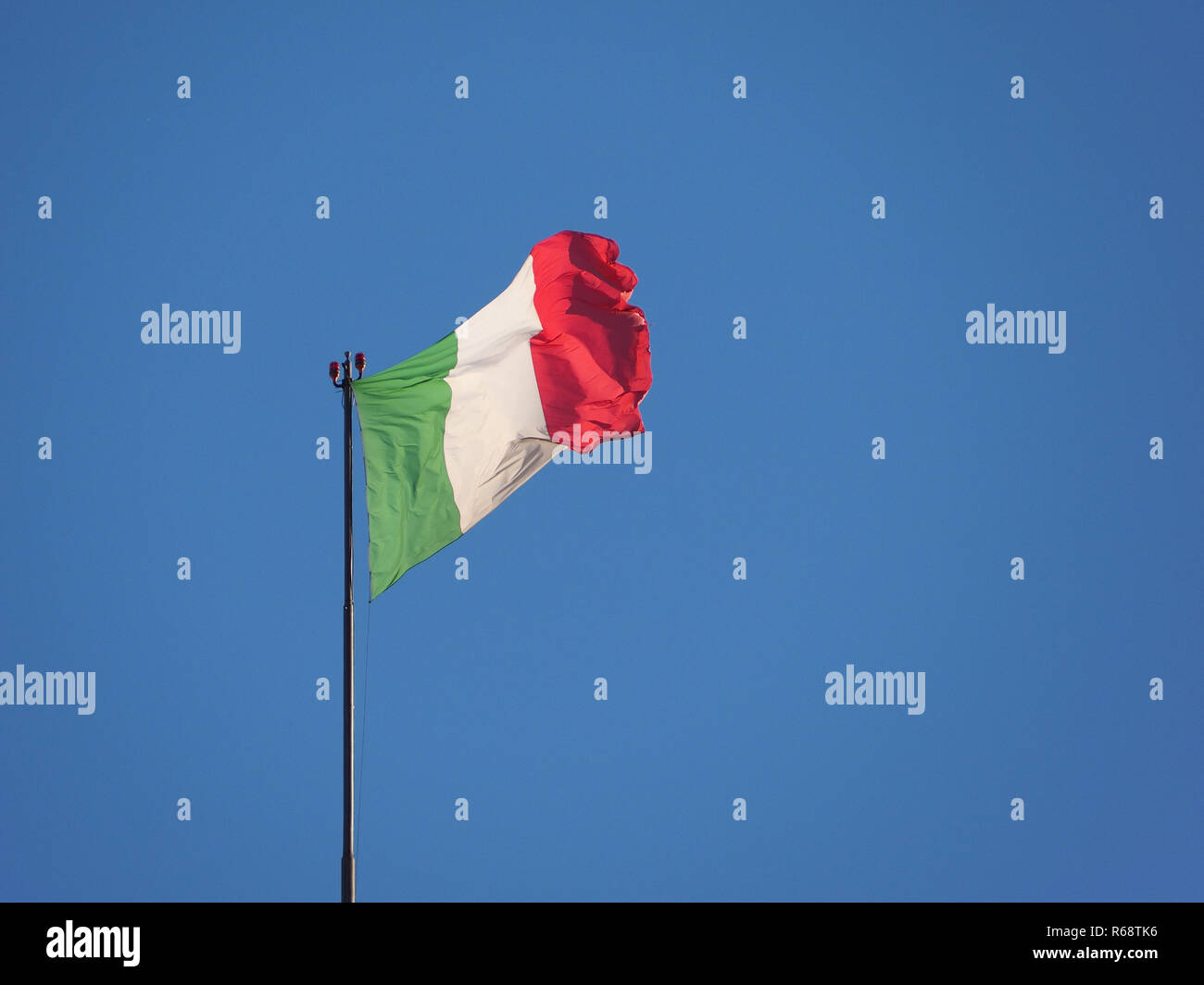 Italian Flag of Italy over blue sky Stock Photo - Alamy