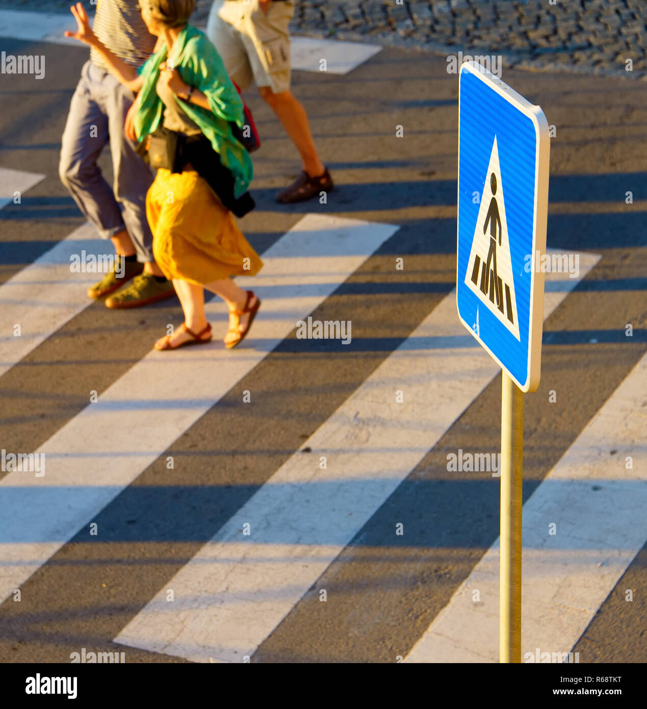 Crosswalk sign. People on background Stock Photo - Alamy