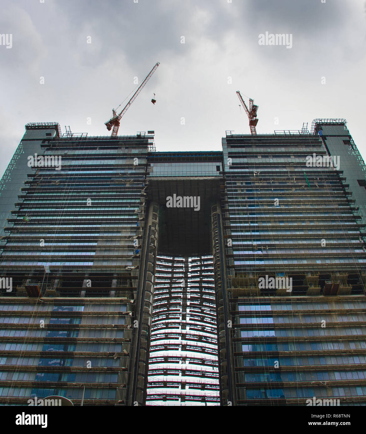 Construction of twin skyscraper, vertical Stock Photo - Alamy