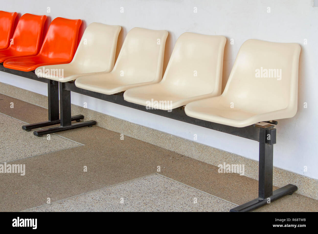 Row chair with cream and orange color Stock Photo - Alamy